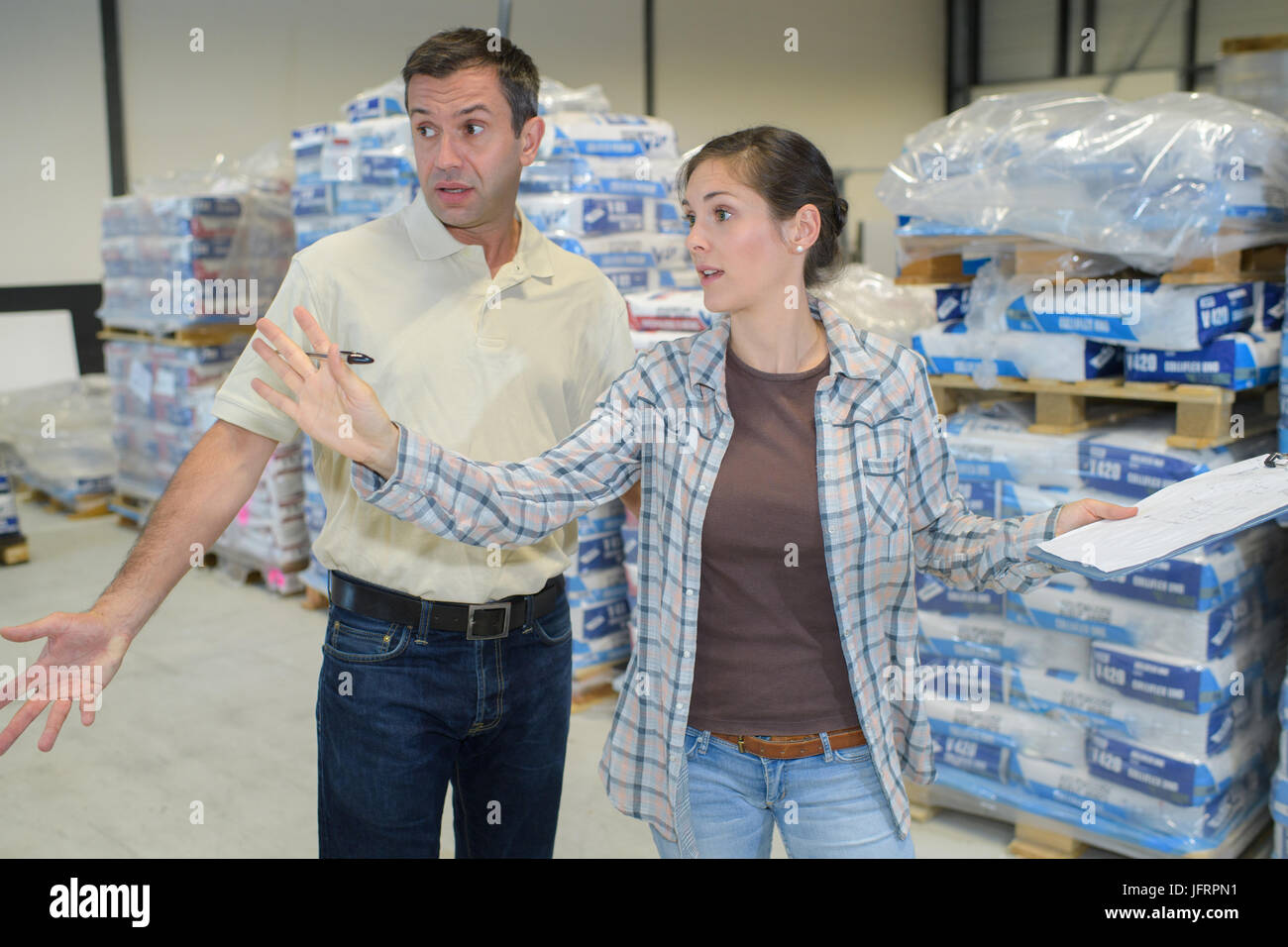 two warehouse workers talking in warehouse Stock Photo - Alamy