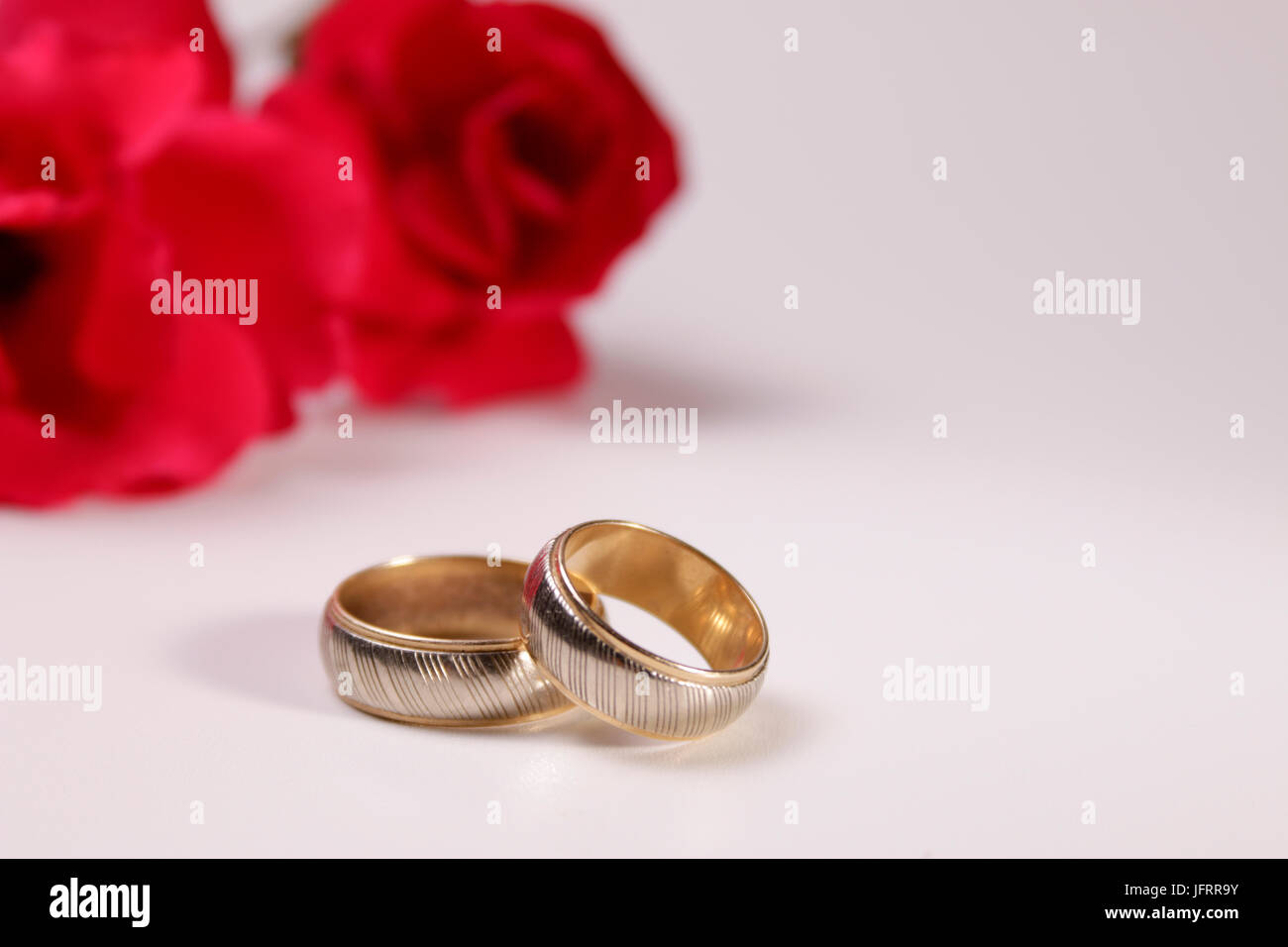 Wedding Rings with Roses Stock Photo - Alamy