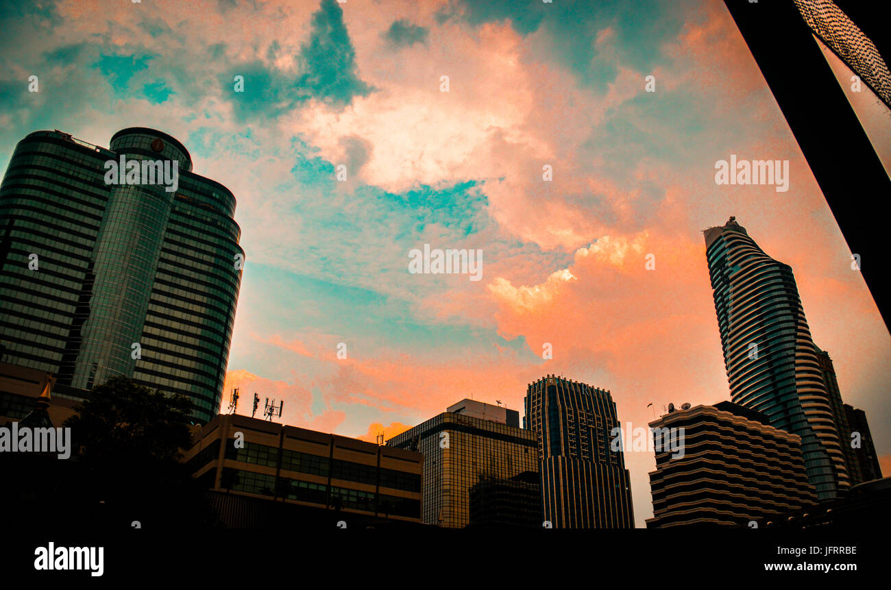Teal sunset reflected on city building Stock Photo - Alamy
