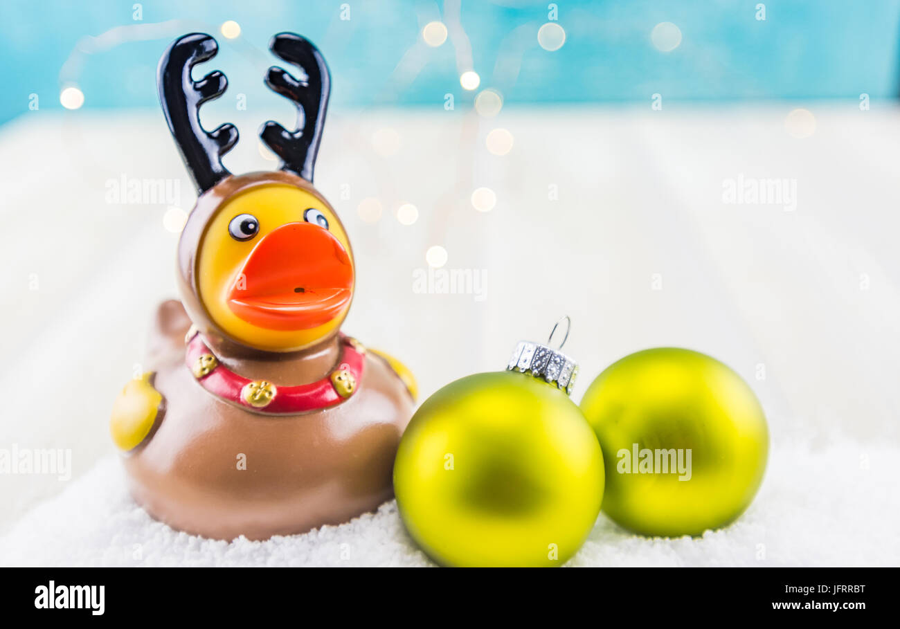 Rubber Duck Reindeer with Two Green Ornaments in snow Stock Photo - Alamy