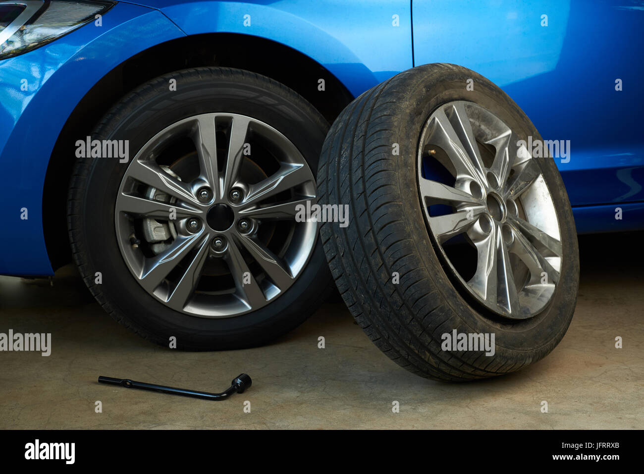 Changed car wheel. Tools for changing broken car wheel Stock Photo - Alamy