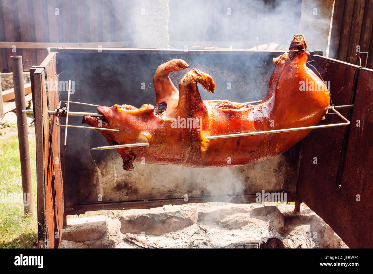 Whole pig roasting on the fire Stock Photo - Alamy