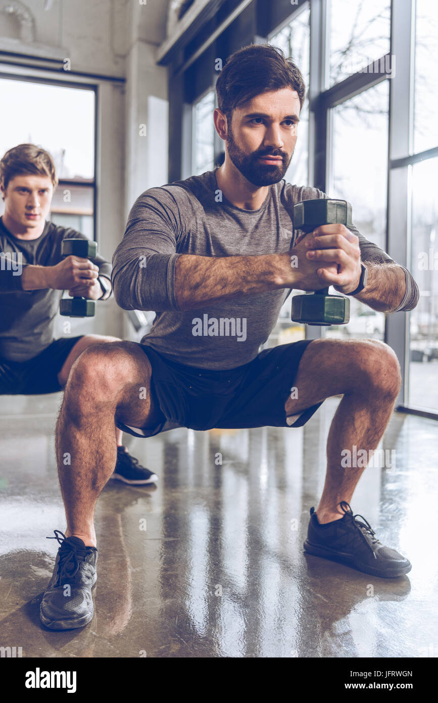 Group men working dumbbells gym hi-res stock photography and images - Alamy