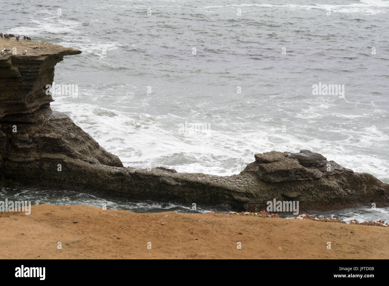 erosion by ocean causing cliffs to fall into water Stock Photo - Alamy