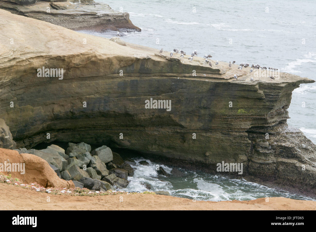 Falling cliffs as result of erosion by Pacific Ocean Stock Photo - Alamy