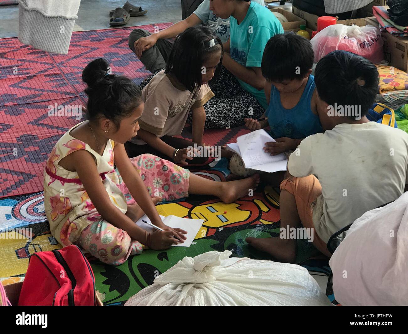Kids draw, sleep or play as their past-time inside Saguiaran evacuation ...
