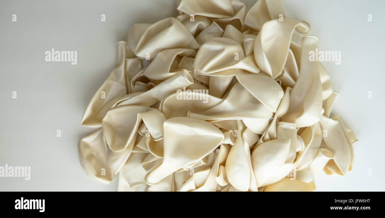 Deflated white rubber air balloon isolated over the white background ...