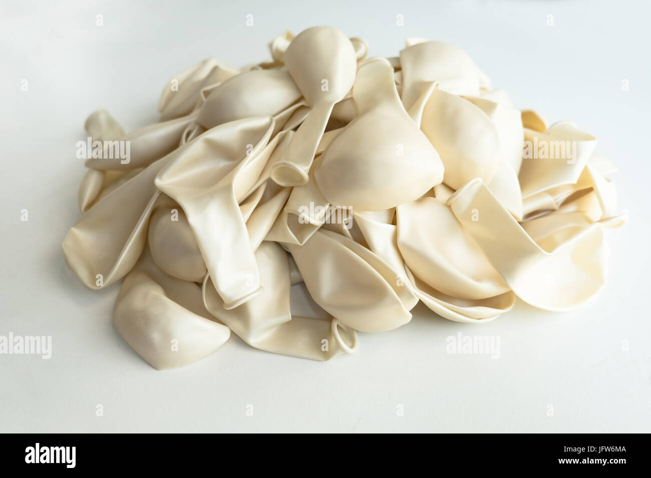 Deflated white rubber air balloon isolated over the white background ...
