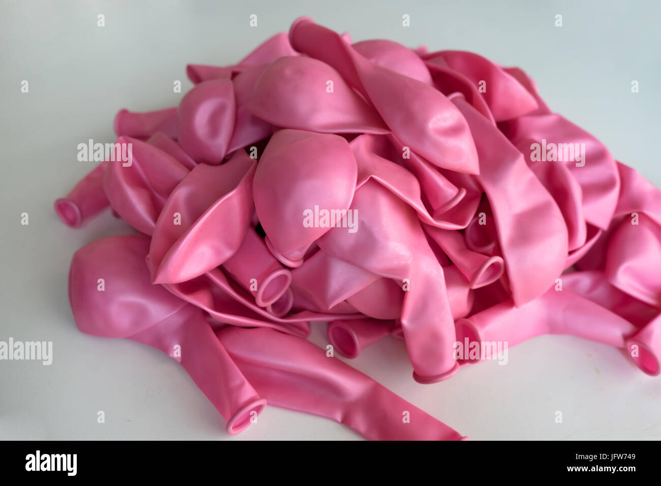 Deflated green with rubber air balloon isolated over the white ...