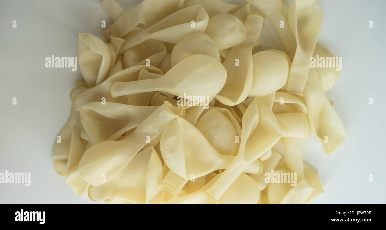 Deflated white rubber air balloon isolated over the white background ...
