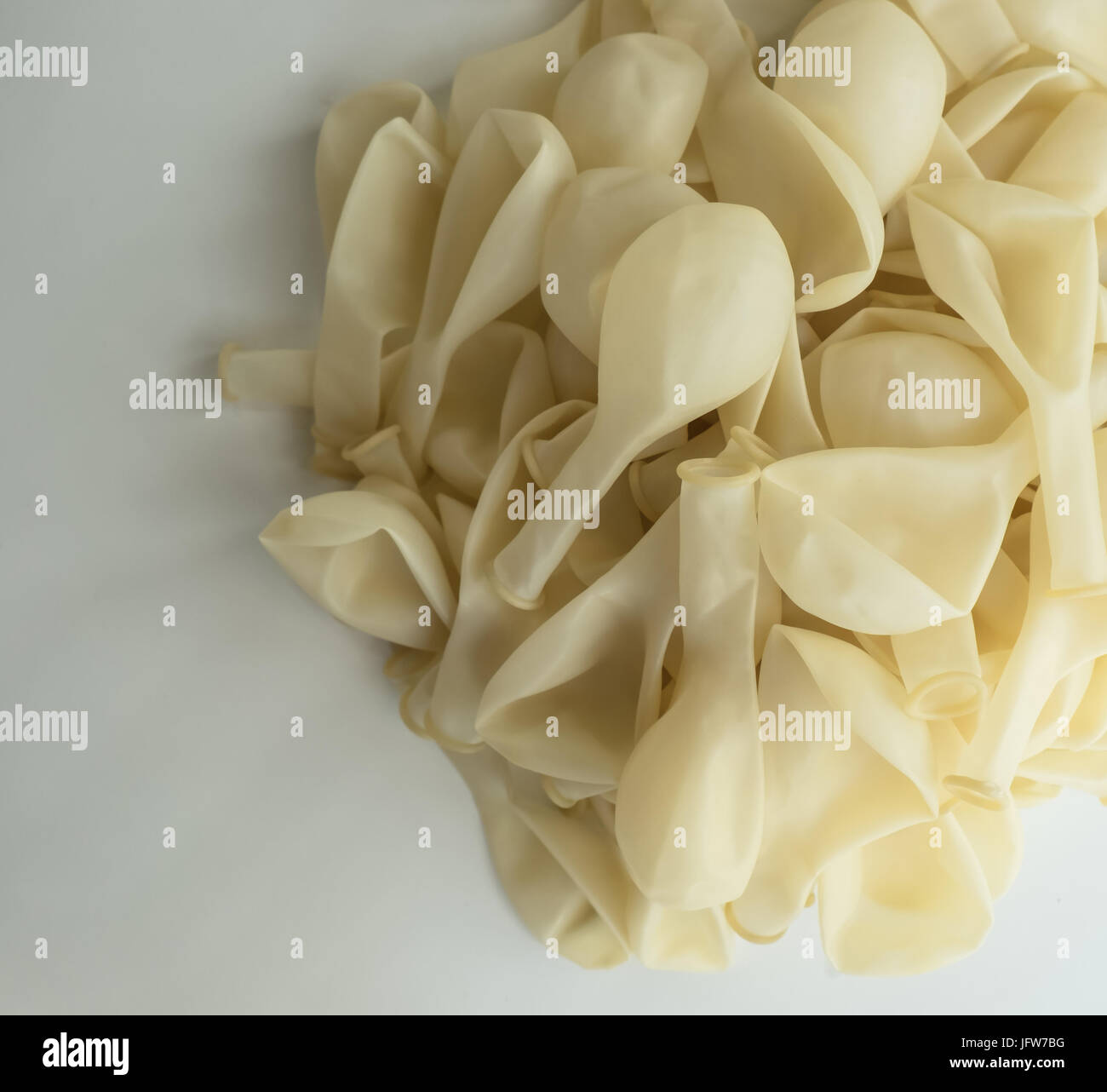 Deflated white rubber air balloon isolated over the white background ...