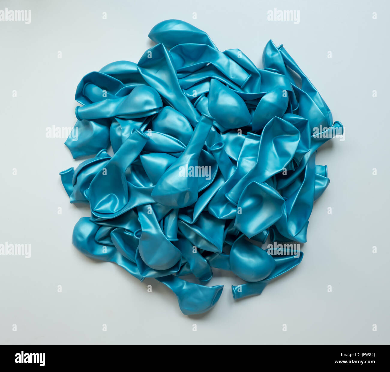 Deflated blue rubber air balloon isolated over the white background ...