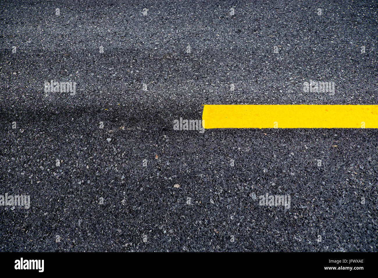 Close up asphalt surface of road divide yellow lines Stock Photo - Alamy