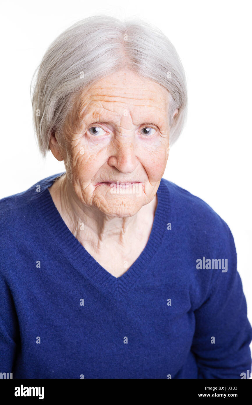 Portrait of senior lady looking up at camera over white background ...