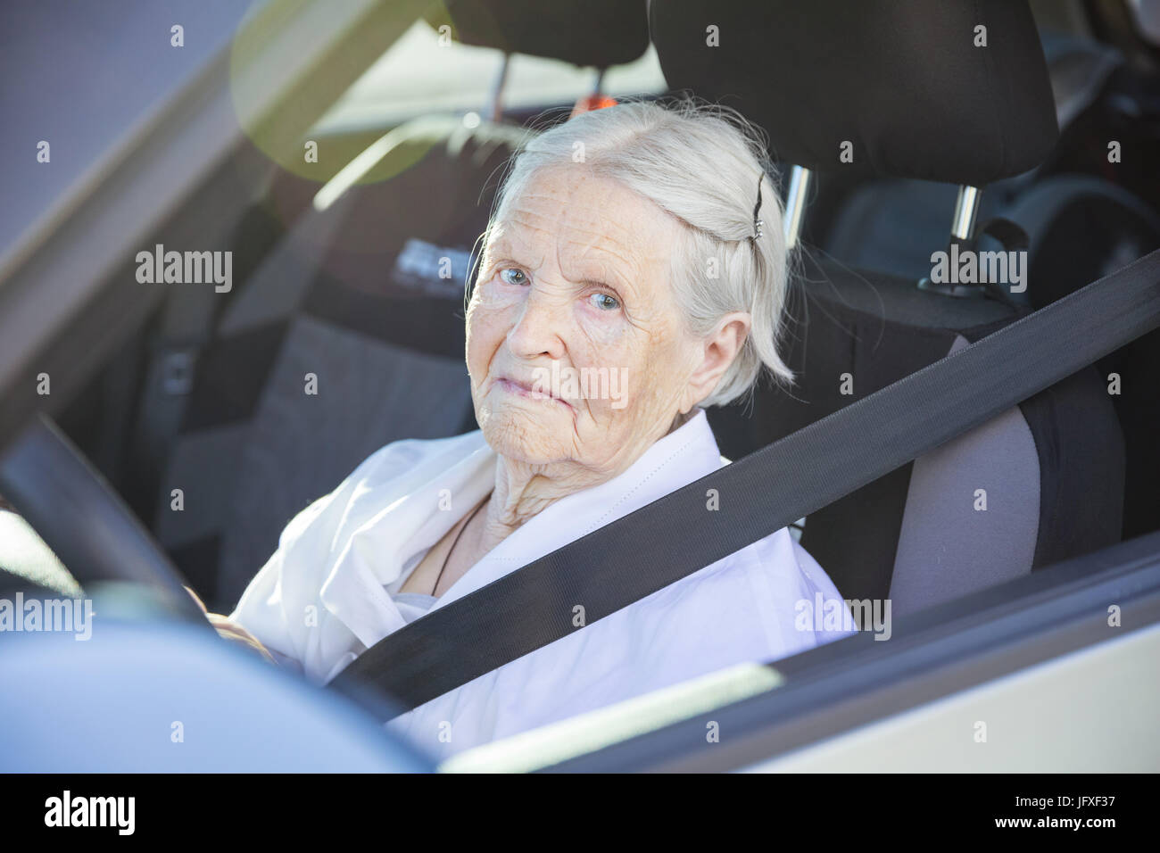 Senior woman driving car on summer day Stock Photo - Alamy