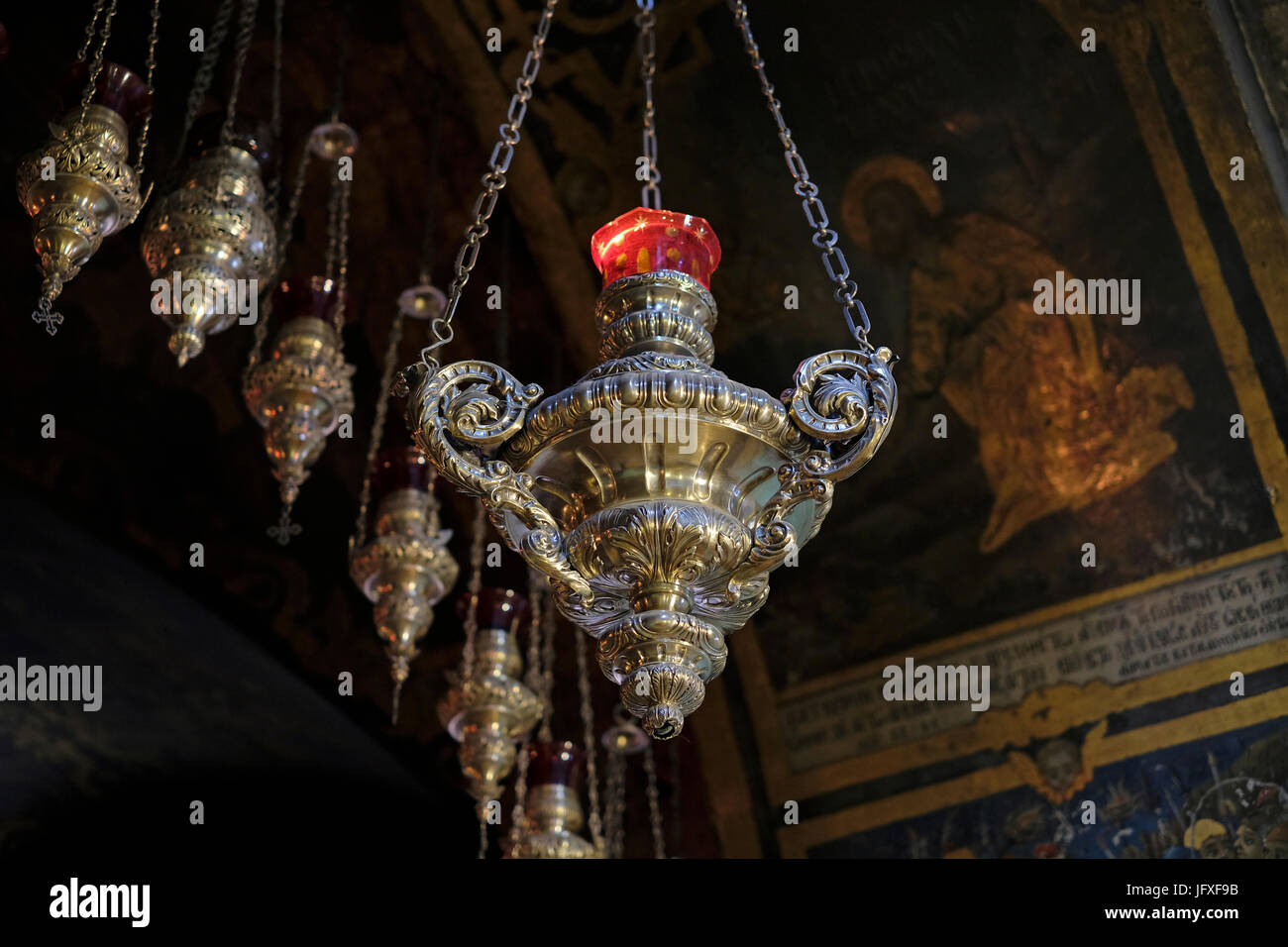 Sanctuary lamps hang at the entrance to the Calvary or Golgotha ...