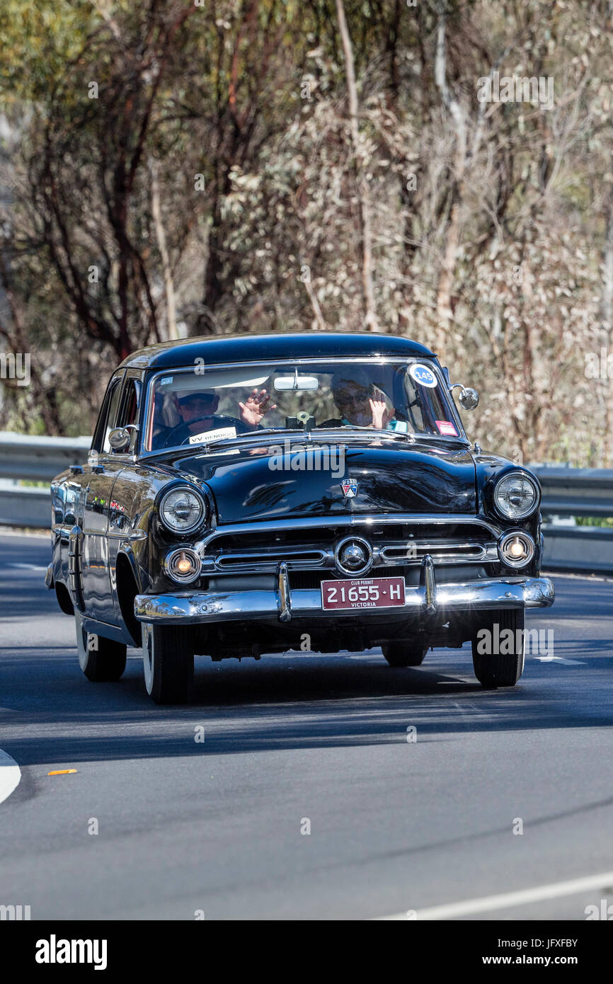 Vintage 1952 Ford Customline sedan driving on country roads near the ...