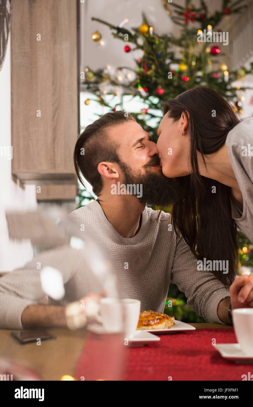 Couple kissing at breakfast table Stock Photo - Alamy