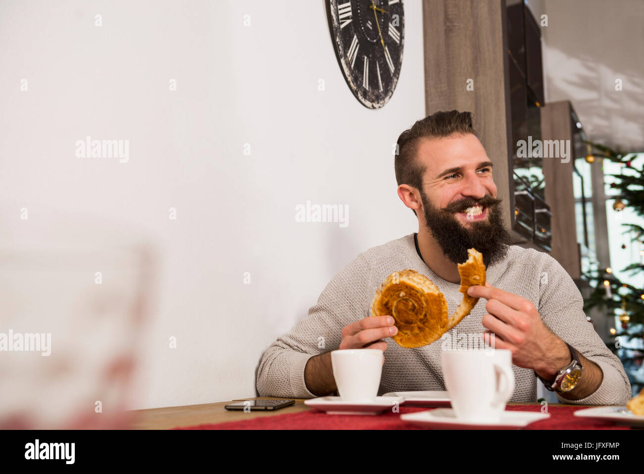 Man eating rolled bun Stock Photo - Alamy
