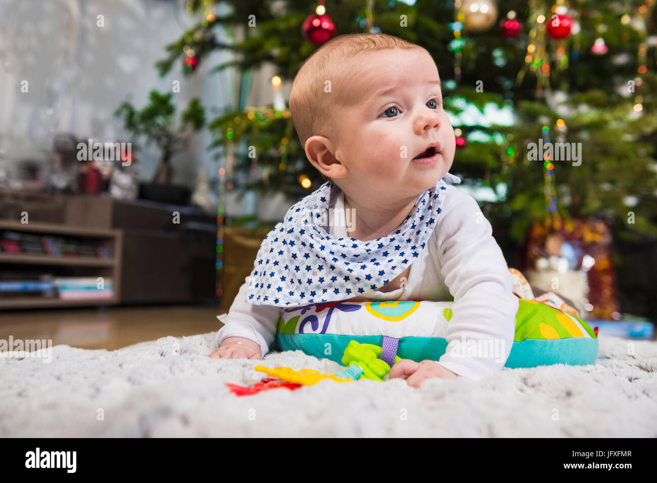 Baby lying on carpet Stock Photo - Alamy