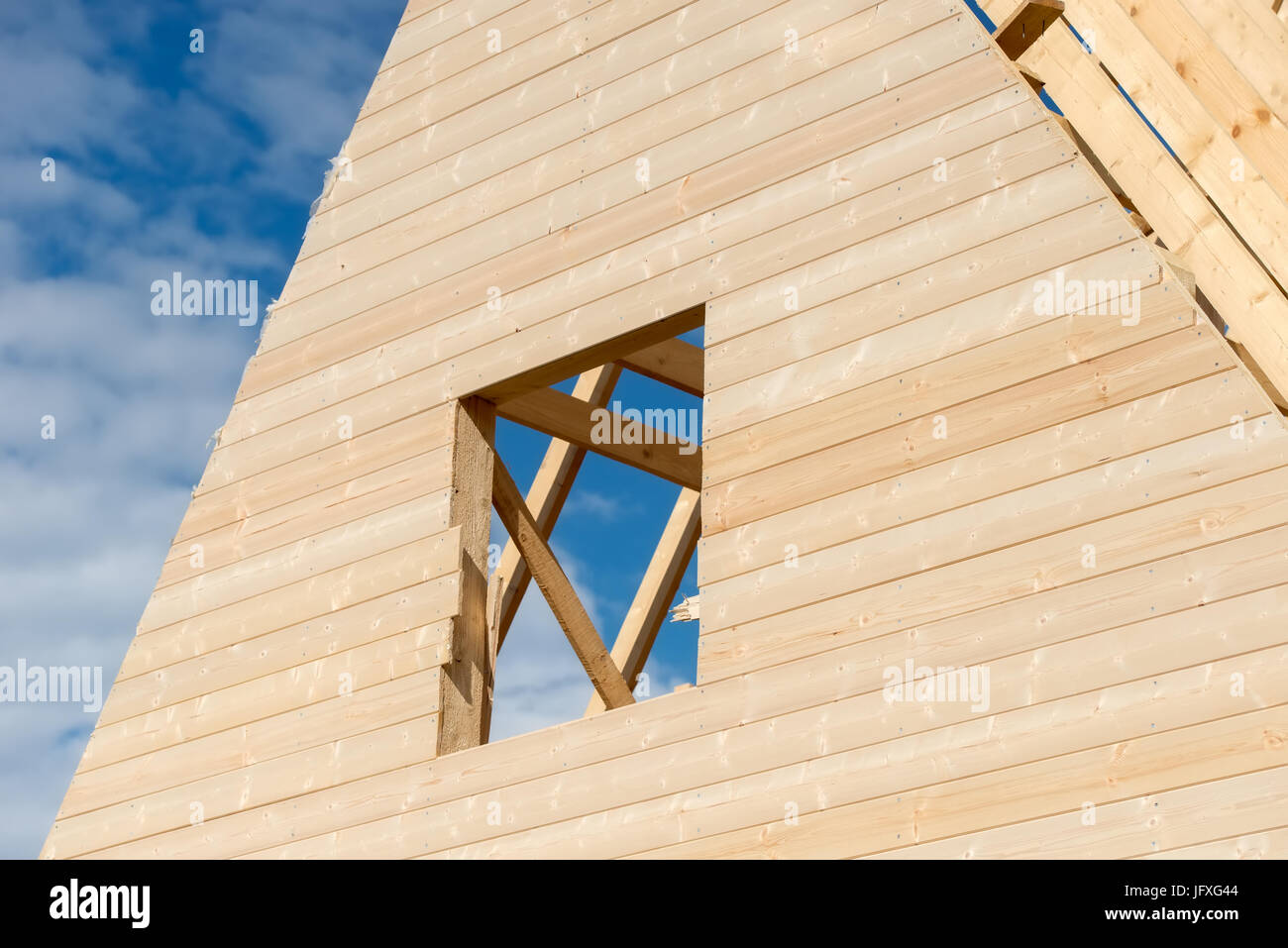 The window opening in the wall of a new wooden house under construction ...