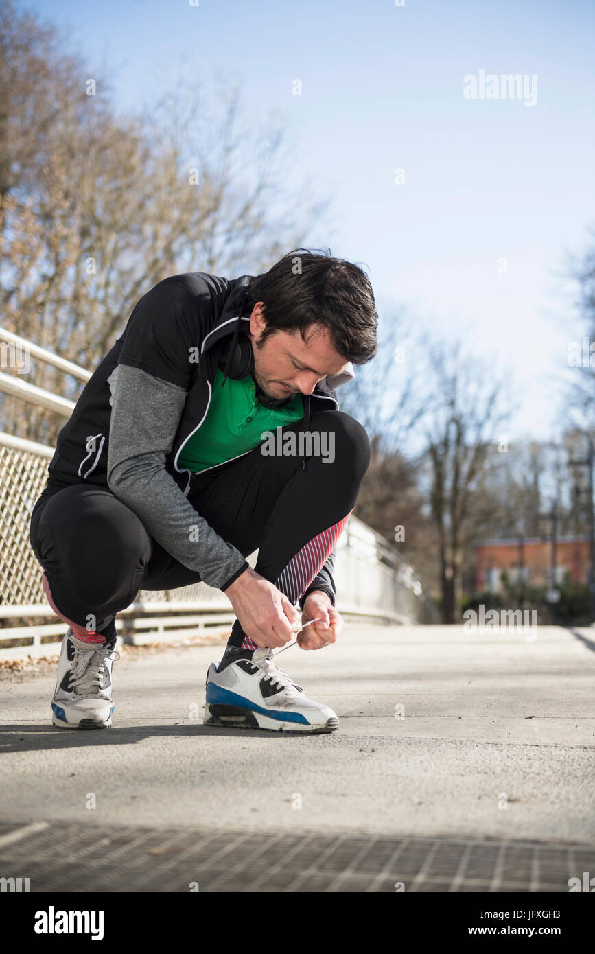 Low Section of man jogging on bridge Stock Photo - Alamy