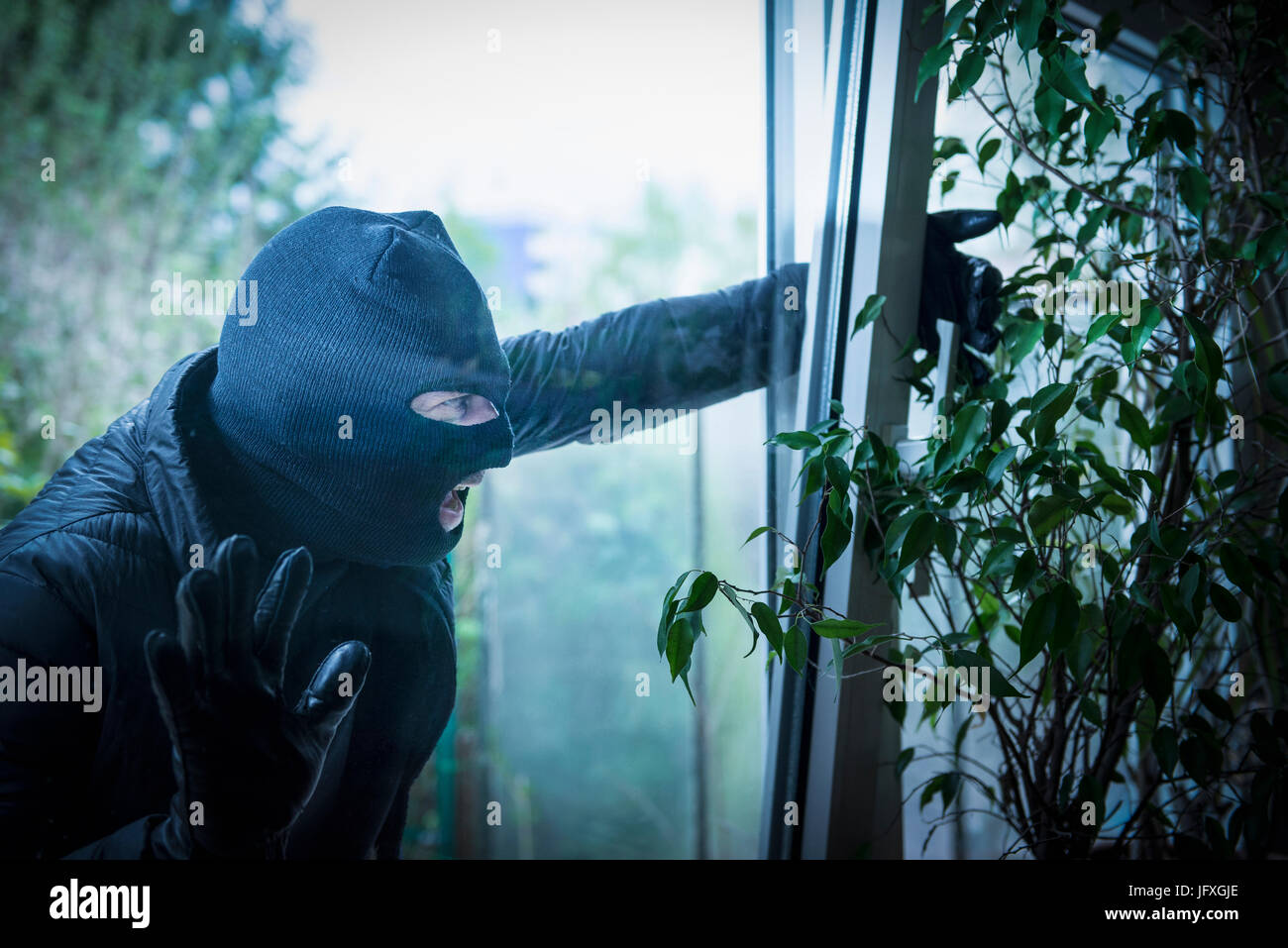 Burglar opening window hi-res stock photography and images - Alamy