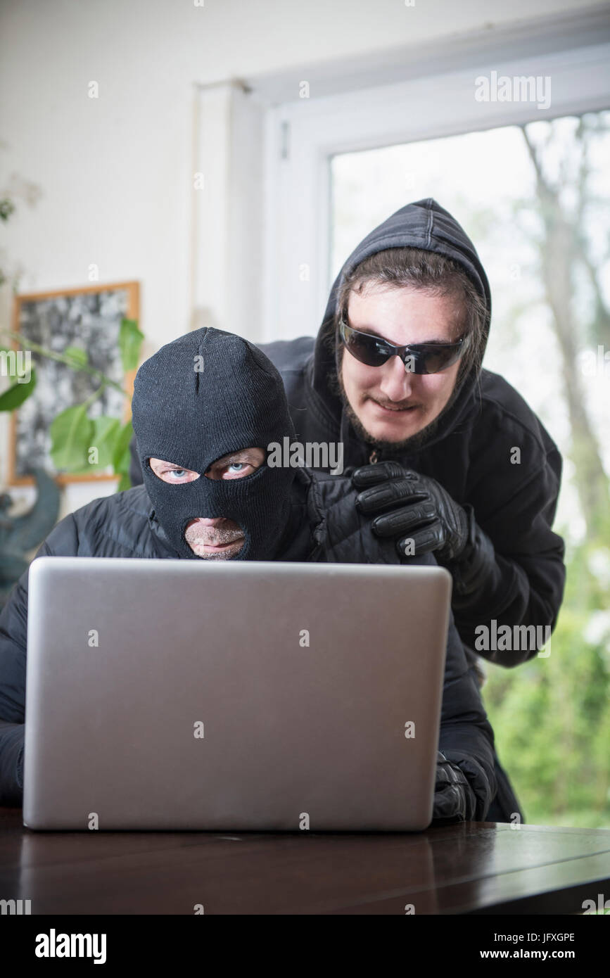 Hackers stealing data from laptop Stock Photo - Alamy