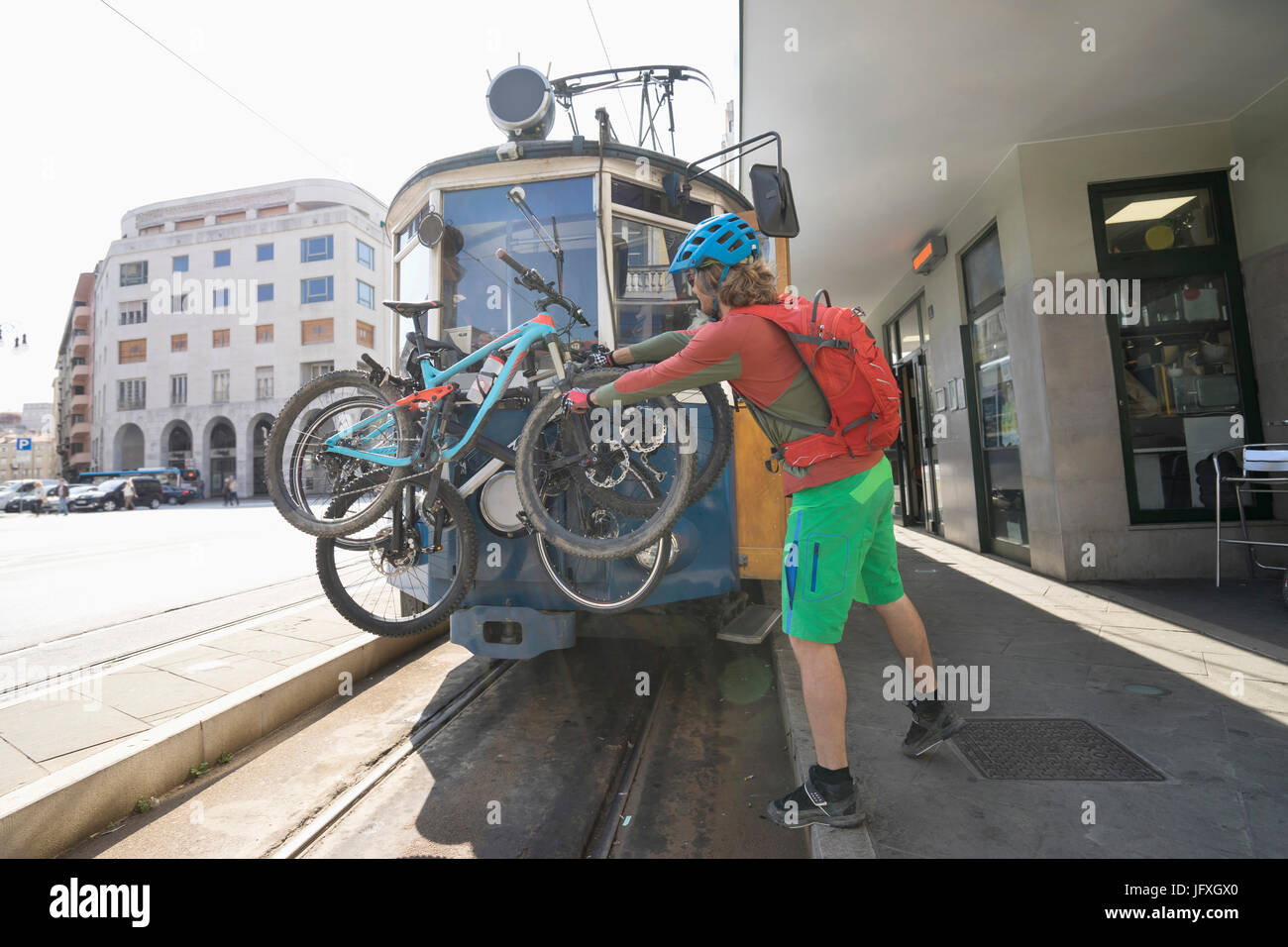 Young biker loading bikes on cable car Stock Photo - Alamy