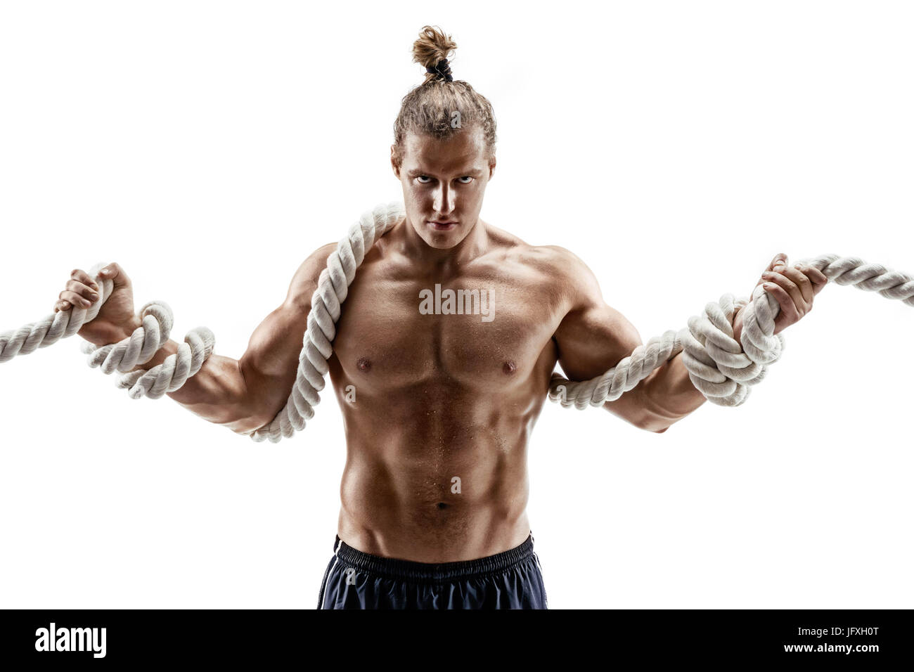 Strong muscular man working out with heavy ropes. Photo of young man ...