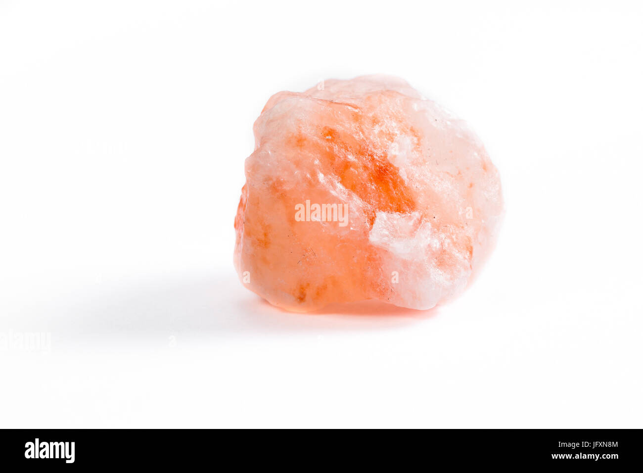 close up of a Himalayan pink salt rock on a white background Stock ...