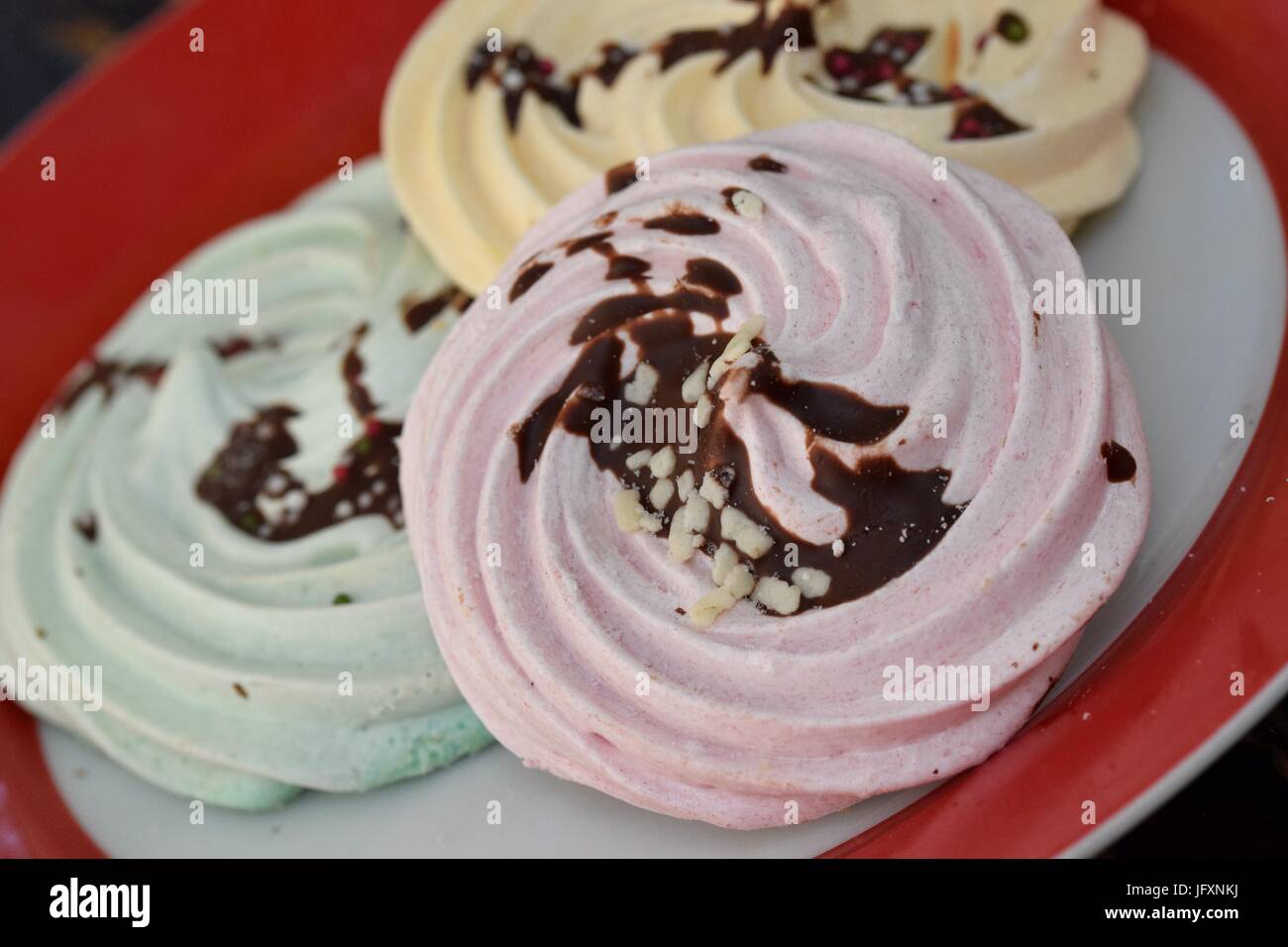 Close view on crisp cream pink, green and yellow cookie Stock Photo - Alamy