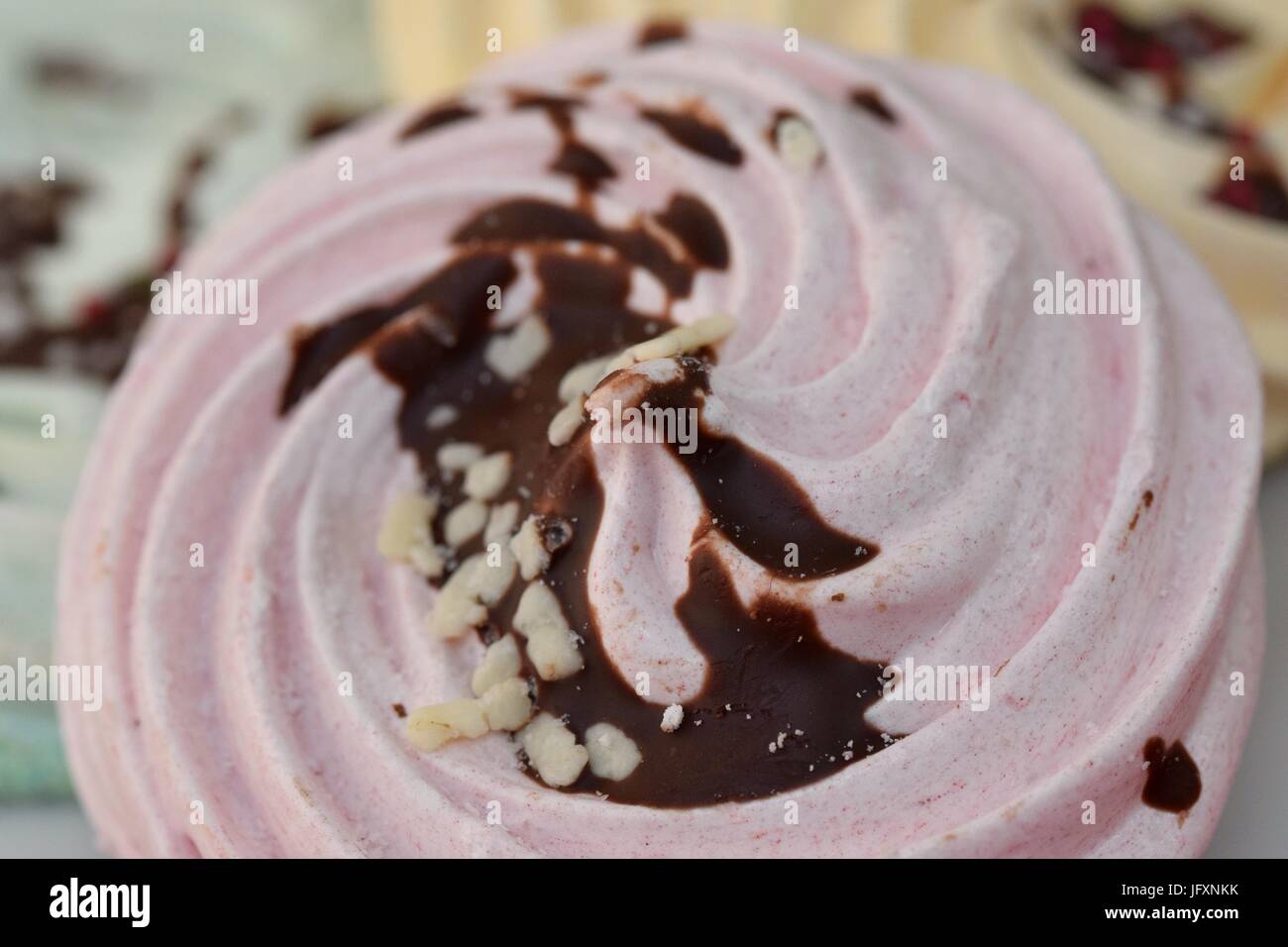 Close view on crisp cream pink, green and yellow cookie Stock Photo - Alamy