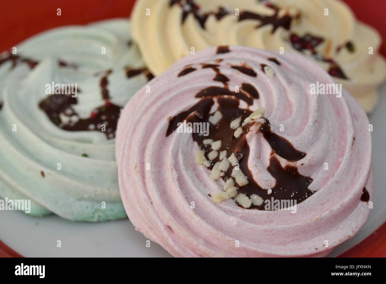 Close view on crisp cream pink, green and yellow cookie Stock Photo - Alamy