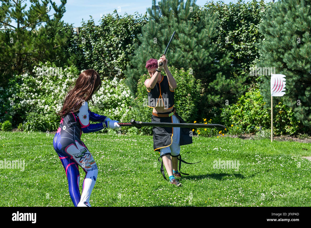 Two cosplay fans duelling with swords. Comic book fans, film fans and ...