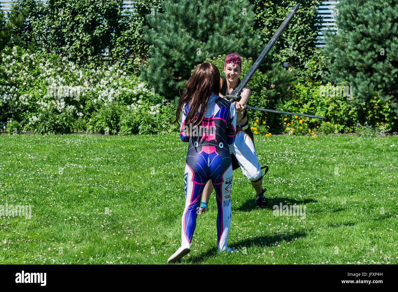 Two cosplay fans duelling with swords. Comic book fans, film fans and ...