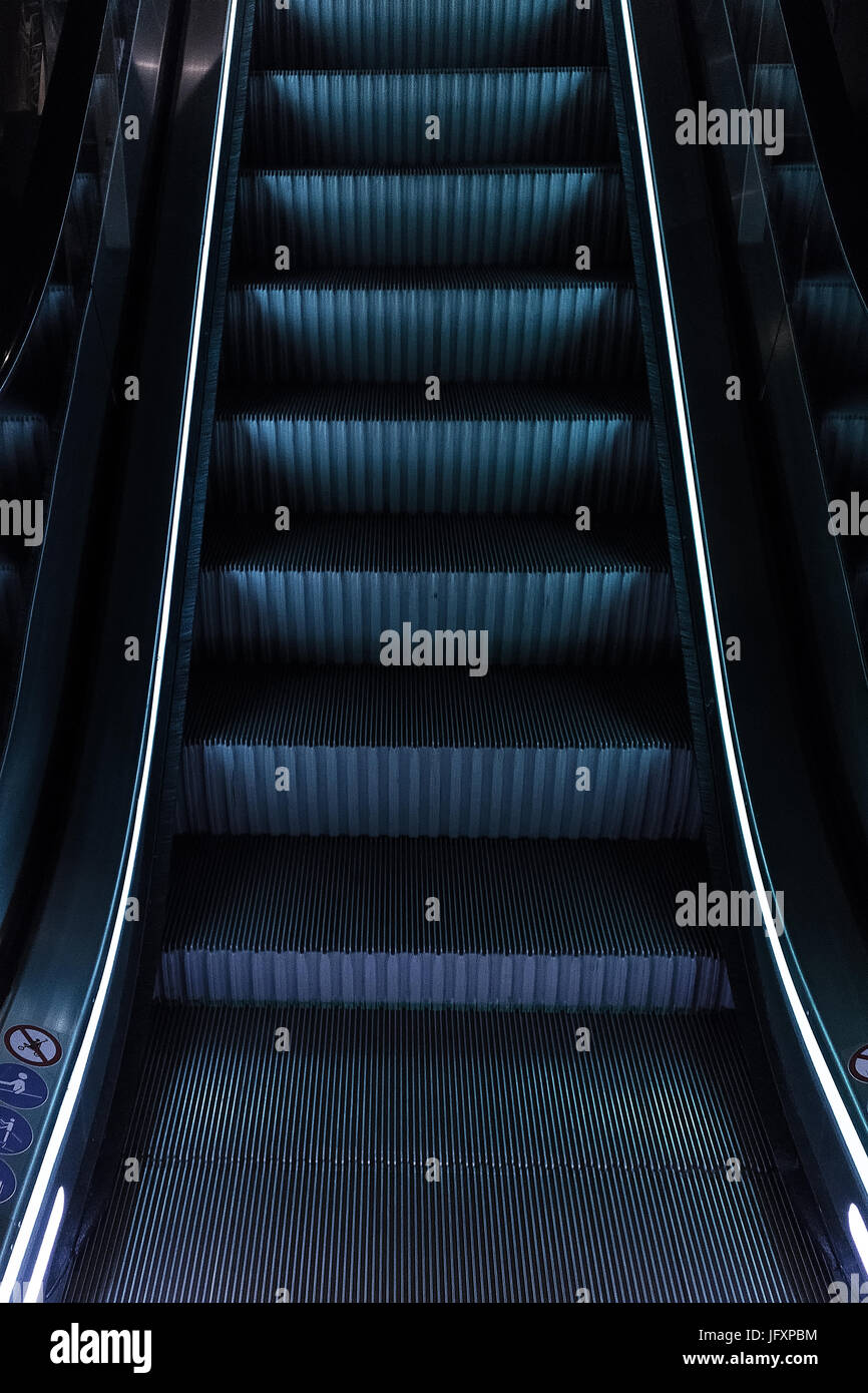 Escalators with blue light Stock Photo - Alamy