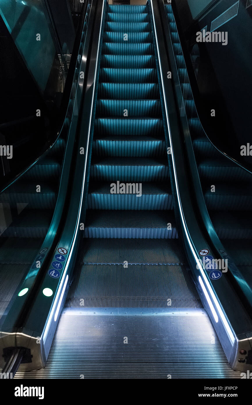 Escalators with blue light Stock Photo - Alamy