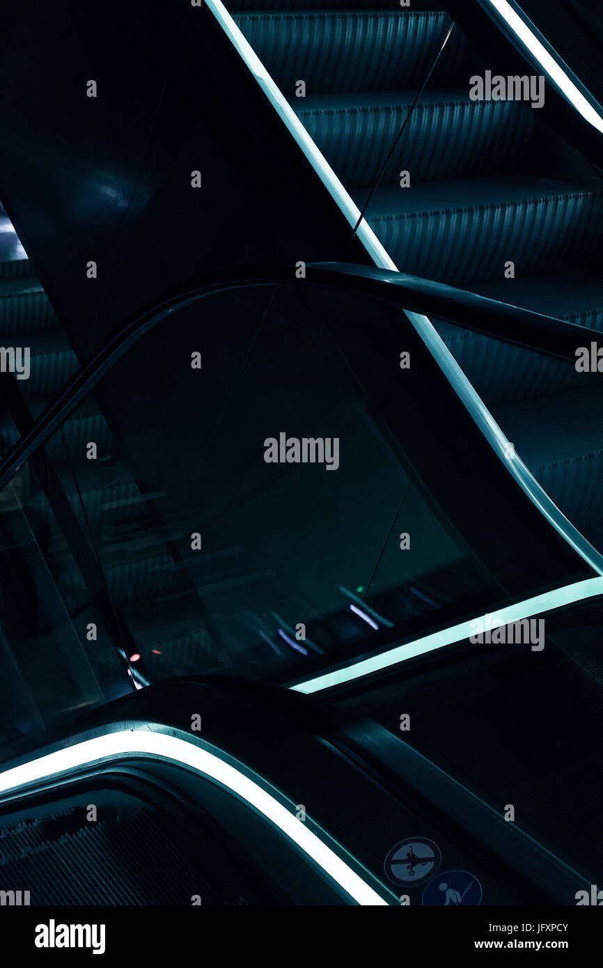 Escalators with blue light Stock Photo - Alamy