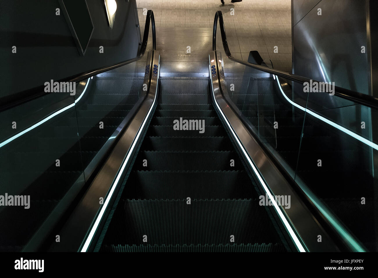 Escalators with blue light Stock Photo - Alamy