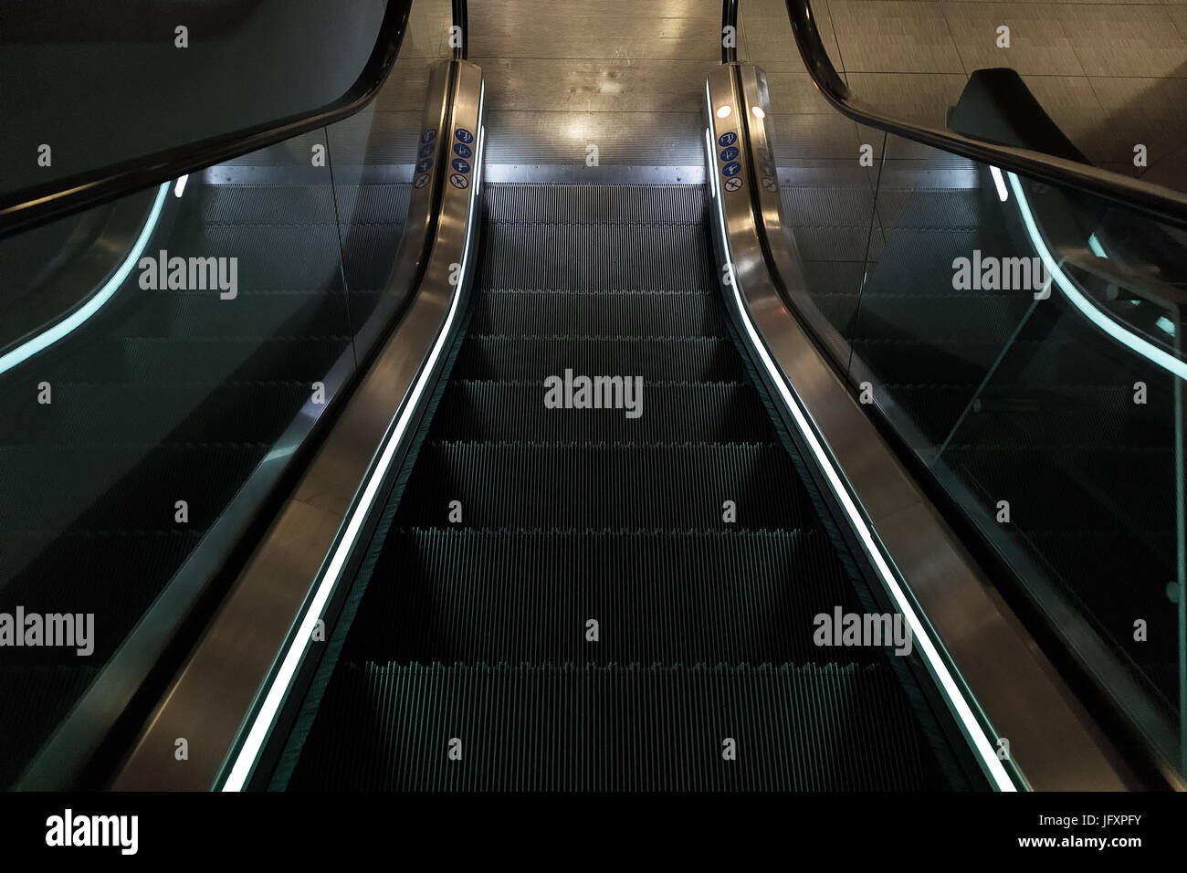 Escalators with blue light Stock Photo - Alamy