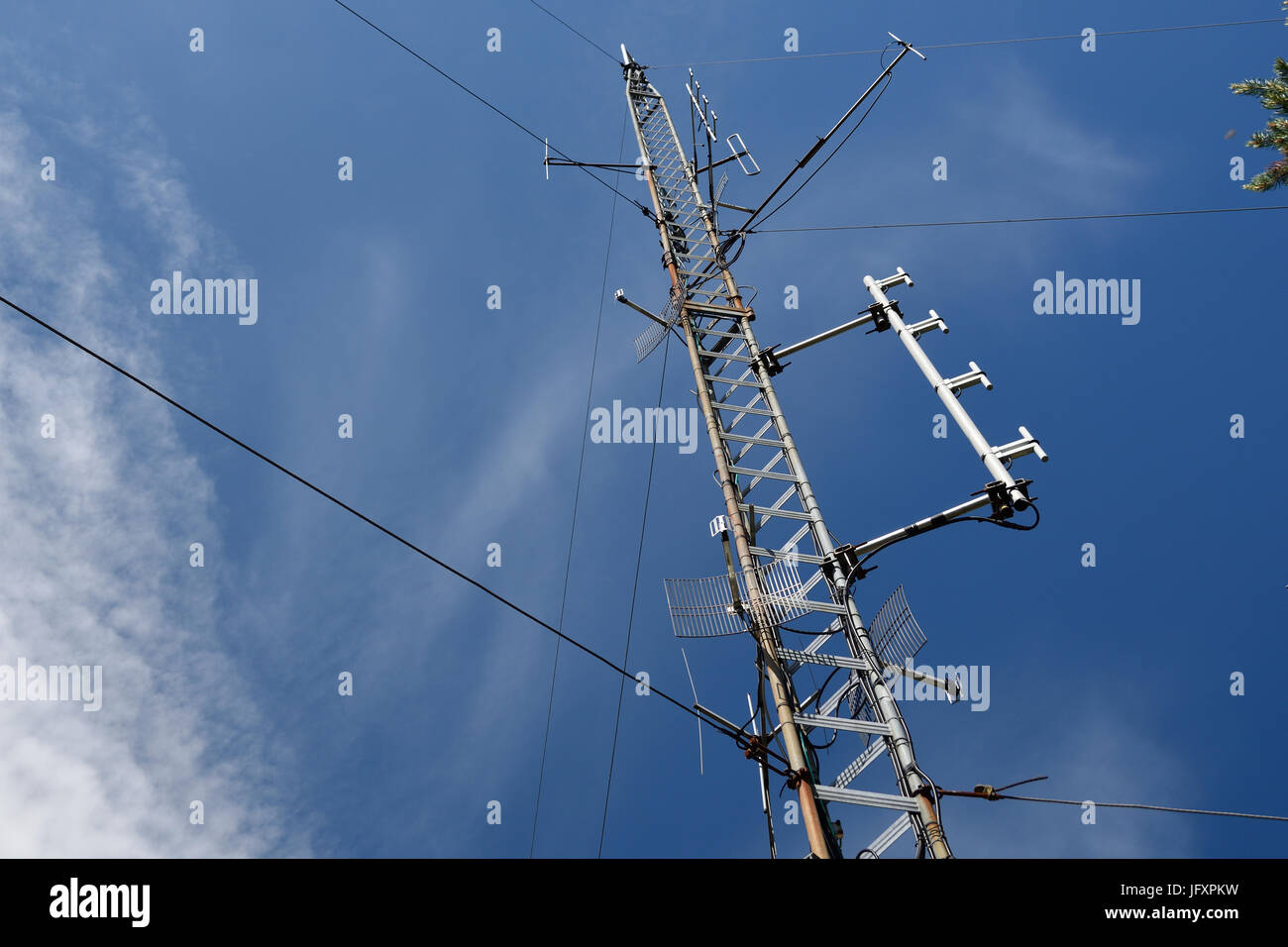 Pylon with a lot of antennas against the blue sky, picture from the ...