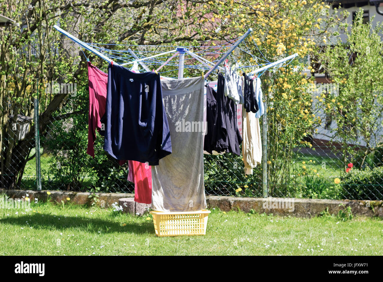 Laundry hanging on clothline outdoor in the garden Stock Photo - Alamy