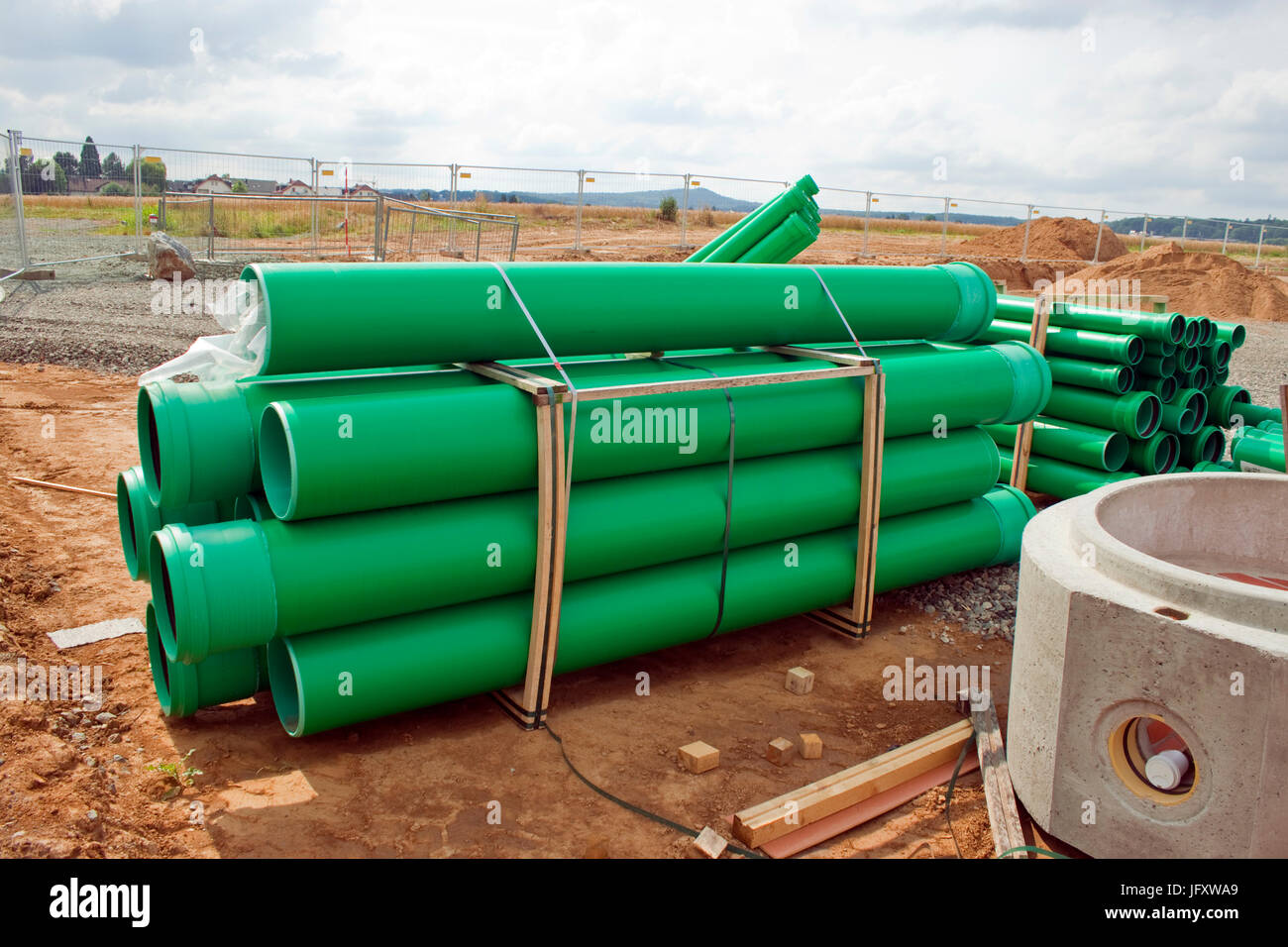 Stack of green sewer pipes on building site outdoor shot Stock Photo ...