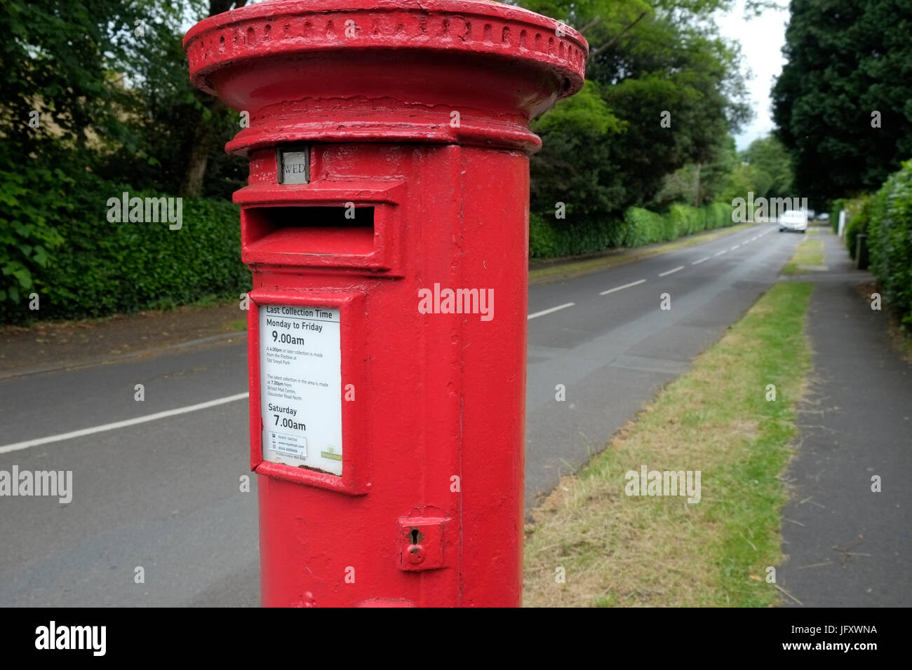 A red Royal Mail post box in a leafy suburb of Bristol Stock Photo - Alamy