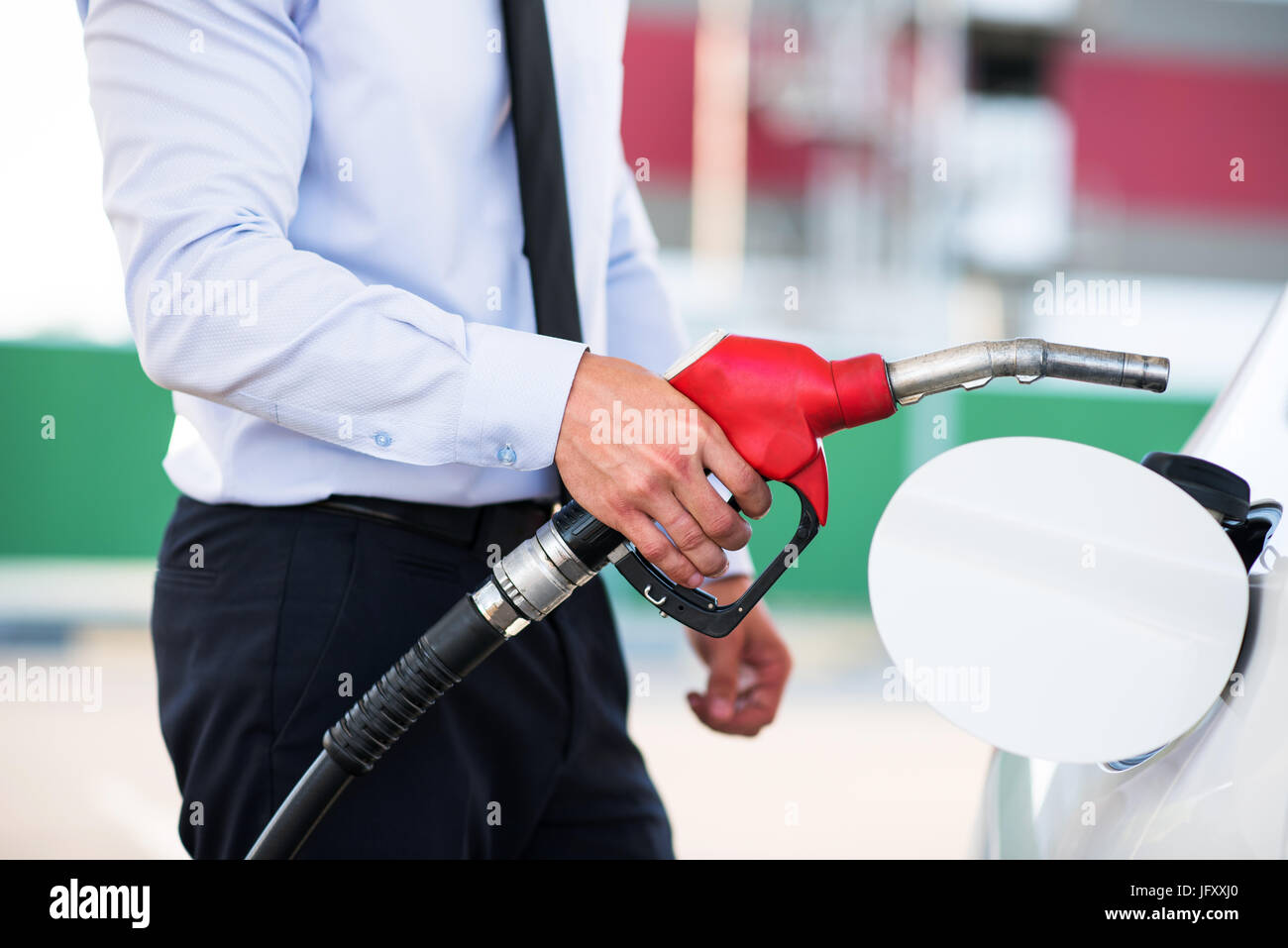 refueling gun is inserted into the tank of car Stock Photo - Alamy
