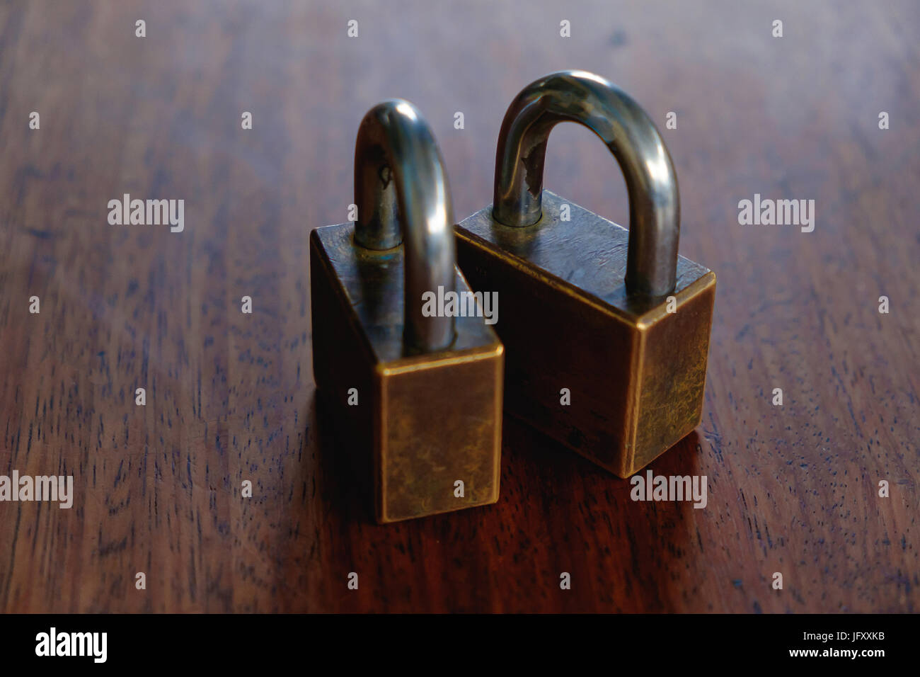 Padlock on the brown wooden table background surface. focus at the ...