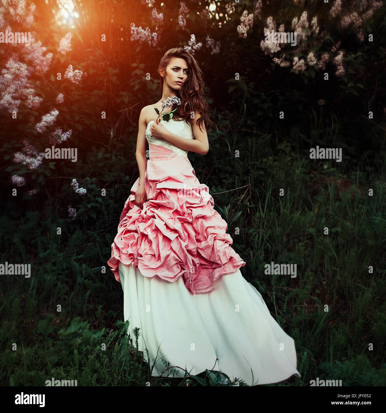 Beautiful And Elegant Woman With Branch Of Lilacs And Hair Waves
