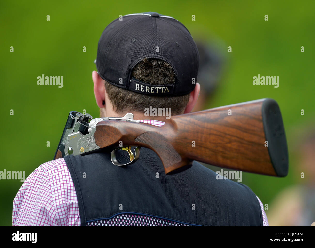 Man with shotgun over shoulder Stock Photo - Alamy