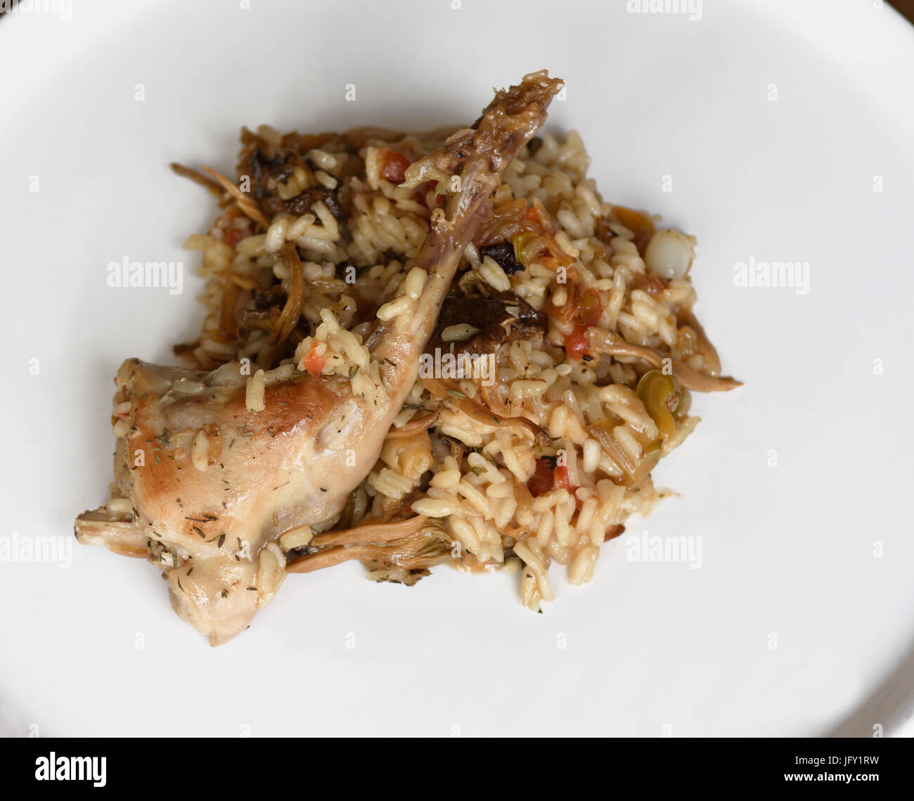 Rice with rabbit and mushrooms Stock Photo - Alamy